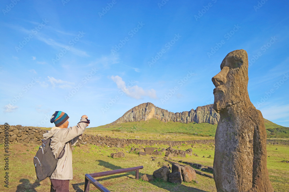 Visitor taking photos of Moai A Vere Ki Haho or "Traveling Moai", a ...