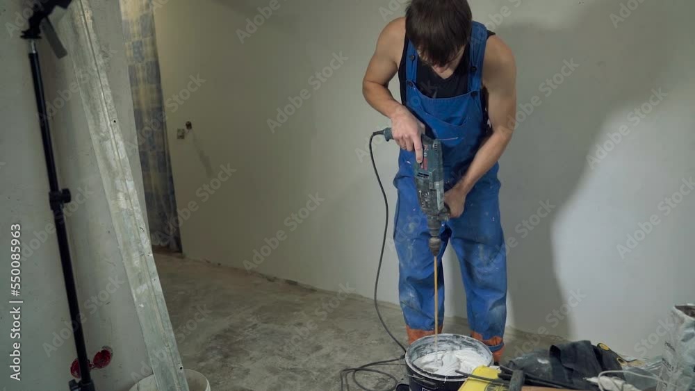 Overall plan. Mixing the building mixture with a tool. Putty for walls ...