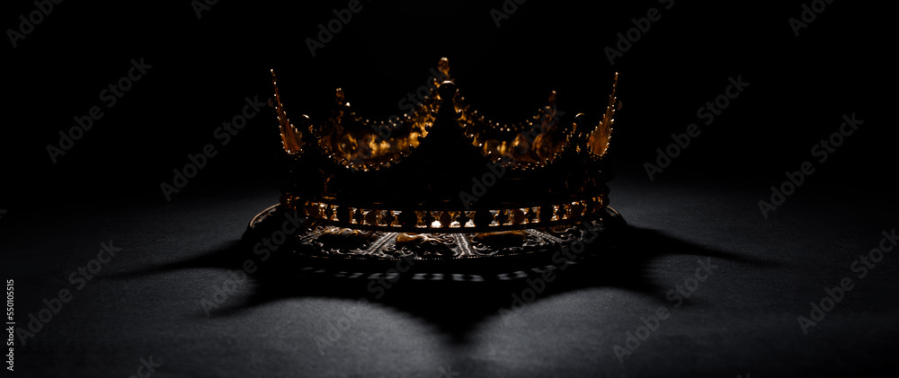 Fabulous golden crown of the king on a dark background. Panoramic view ...