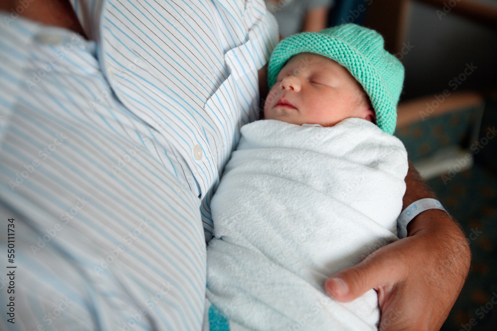 A father holds his new born daughter the day after she was born. Stock ...