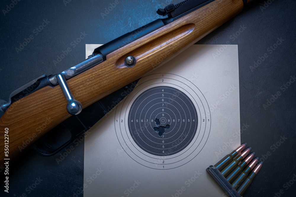 Shooting from a rifle at a target, a bolt action rifle of caliber 7 ...