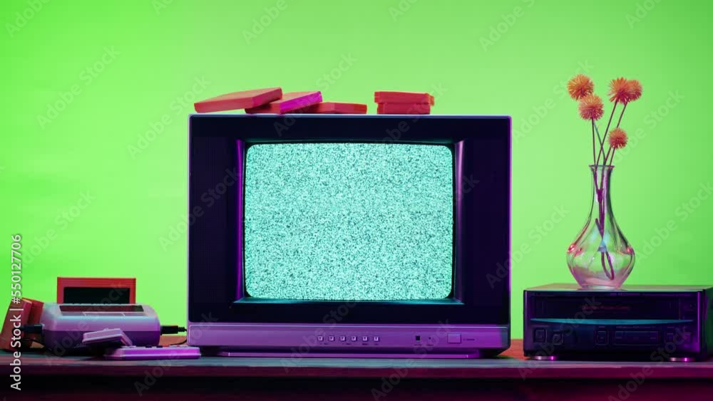 Old television with grey interference screen on purple neon background ...