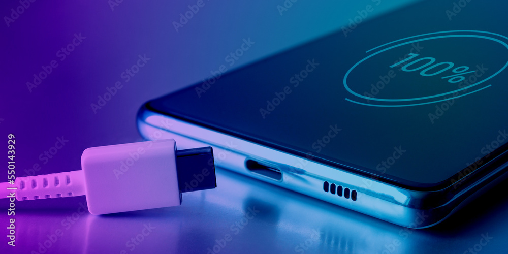 Fully charged battery icon on the touch screen of the cell phone and a ...