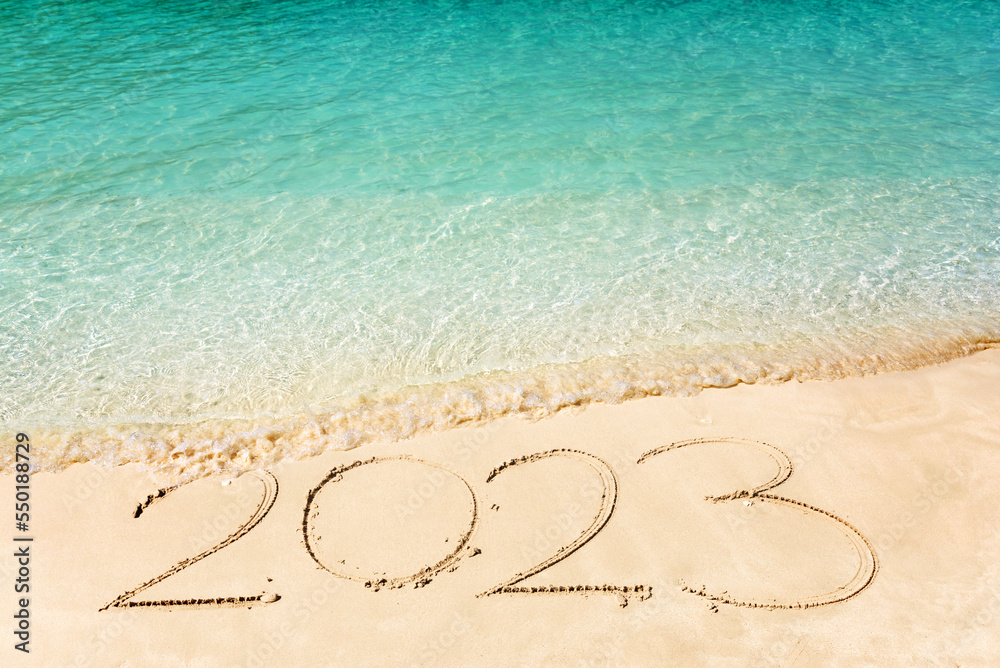 Happy New Year 2023, lettering on the beach with wave and clear blue ...