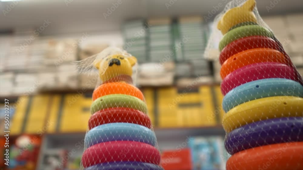 An arc around the base of a kids rainbow coloured hoop stacking toy on ...