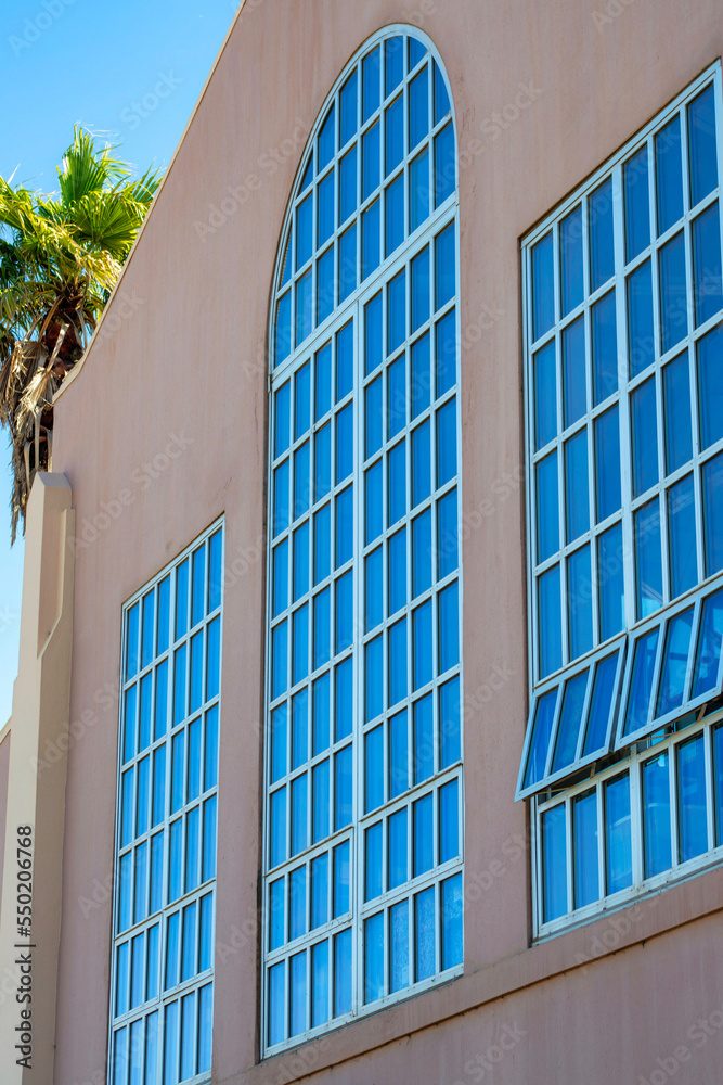 Large glass window with white plastic frames and beige and brown stucco ...