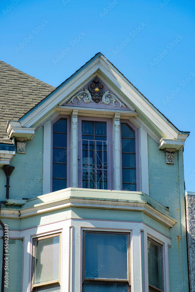 Beige house facade with white accent paint near roof and brown tiles ...
