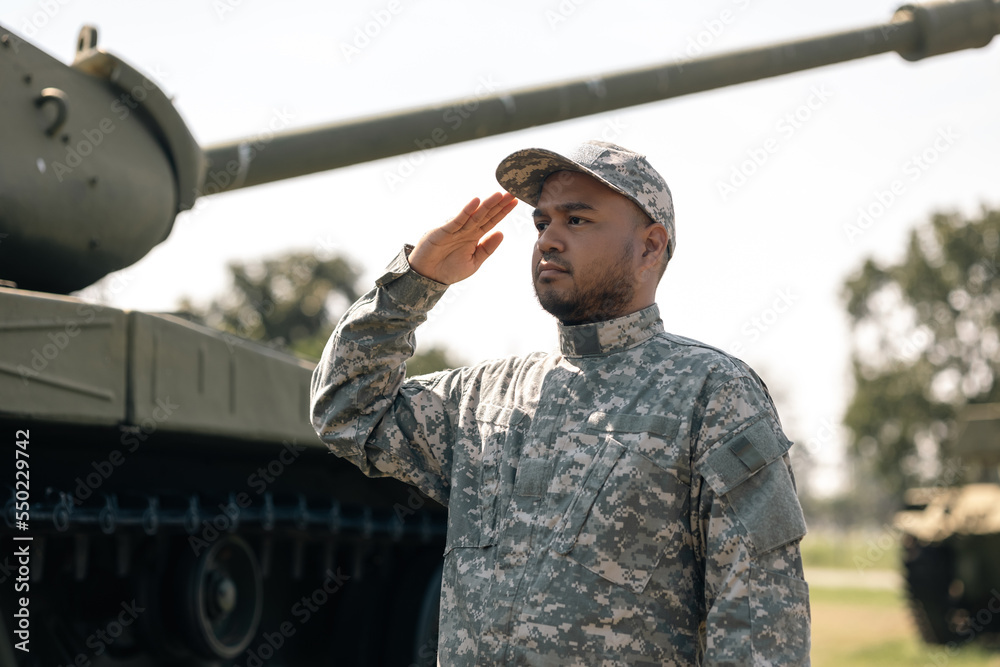 Asian man special forces soldier saluting standing against on the field ...