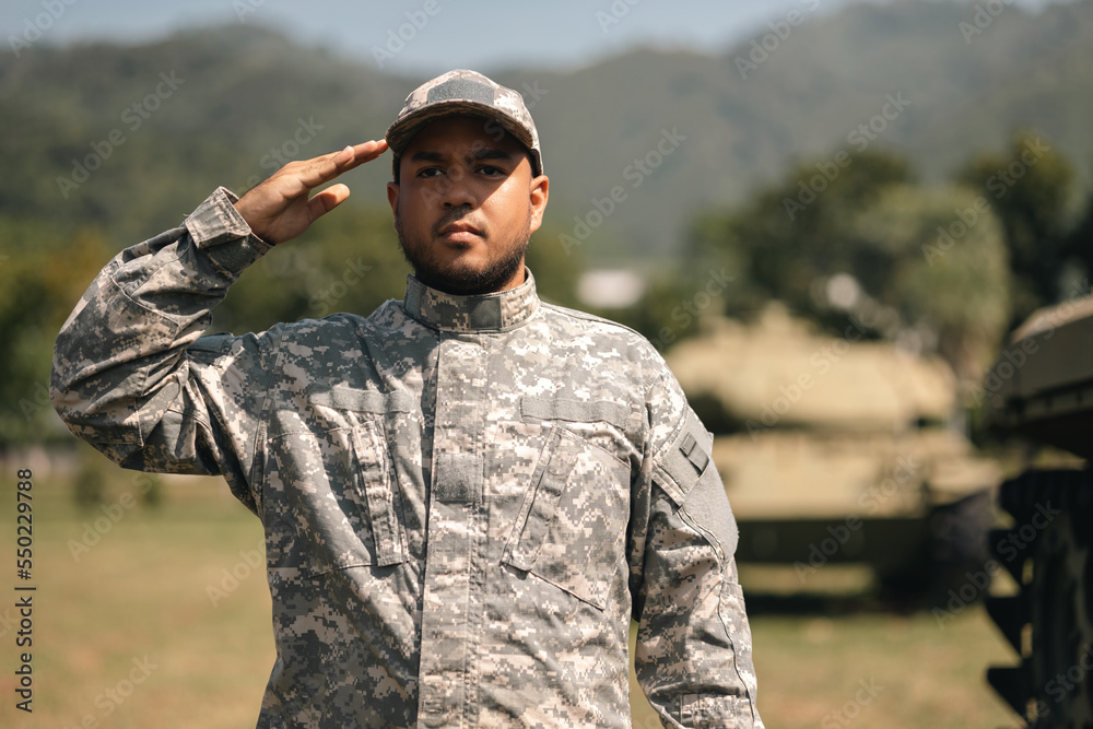 Asian man special forces soldier saluting standing against on the field ...