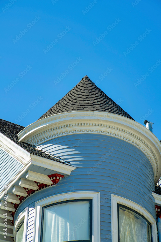 Blue turret or spire on house facade with wooden or timber pannel ...