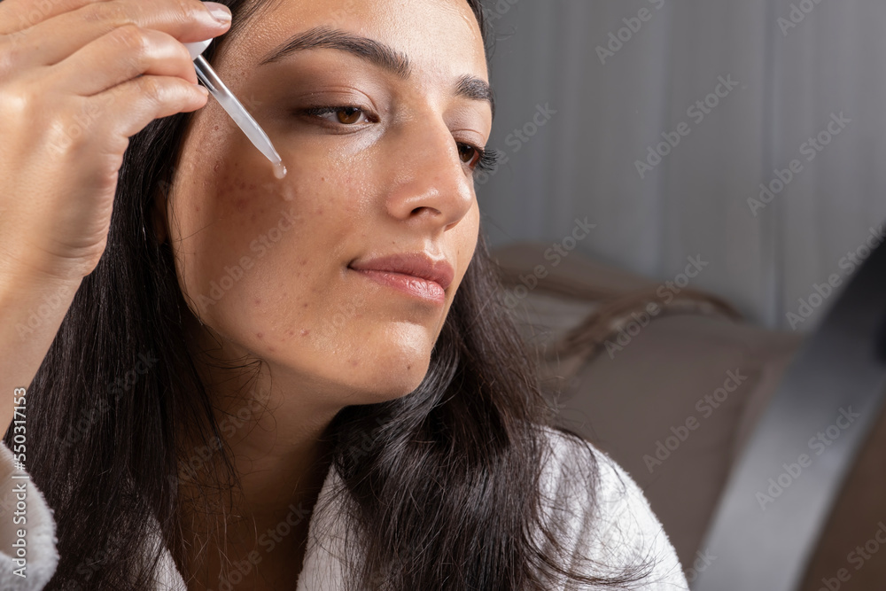 Skin care serum, caucasian millennial woman dripping skin care serum ...