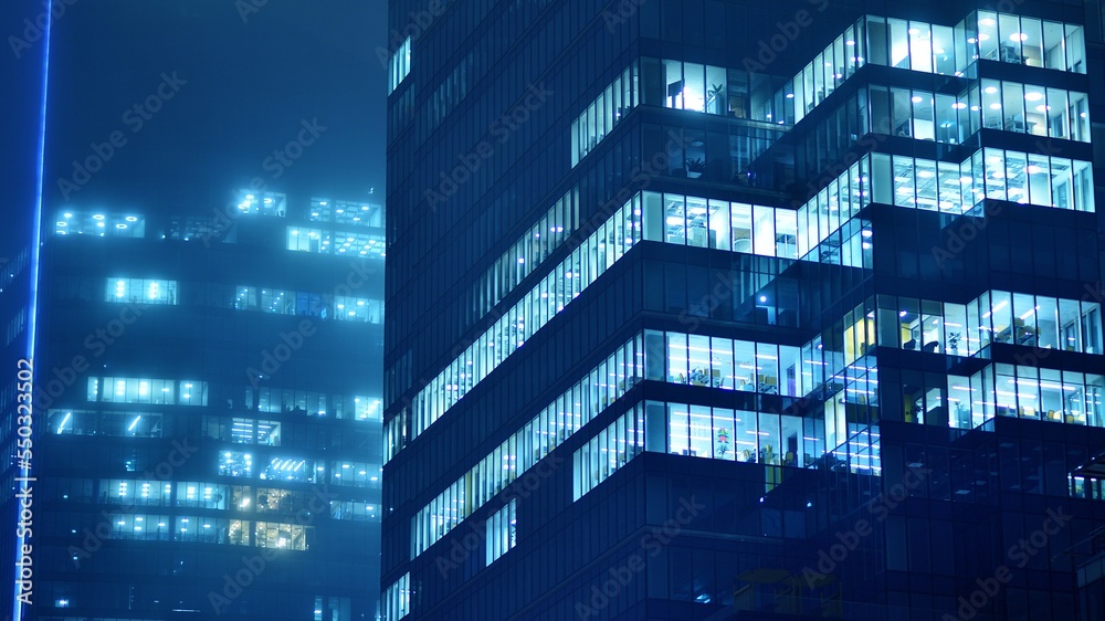 Pattern of office buildings windows illuminated at night. Glass ...