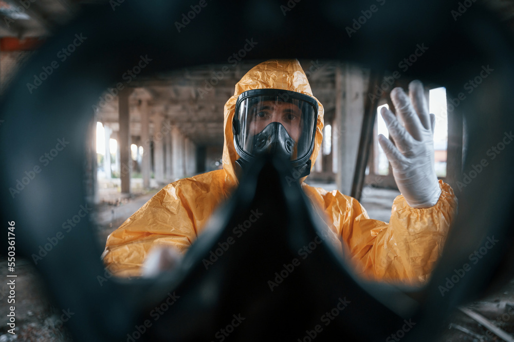 First person view through respirator. Man dressed in chemical ...