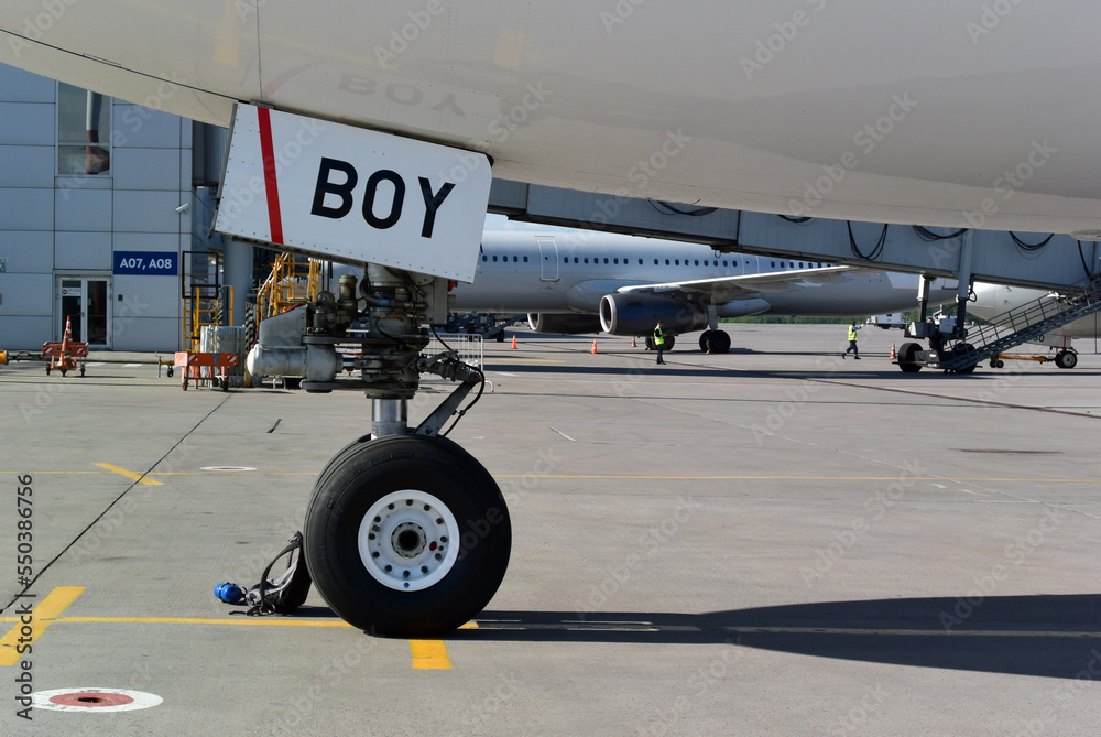 BOY sign on hatch of an aircraft. Horizontal photo with fragment of an ...