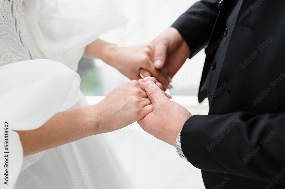 The bride and groom are holding hands. The happy couple celebrate their ...