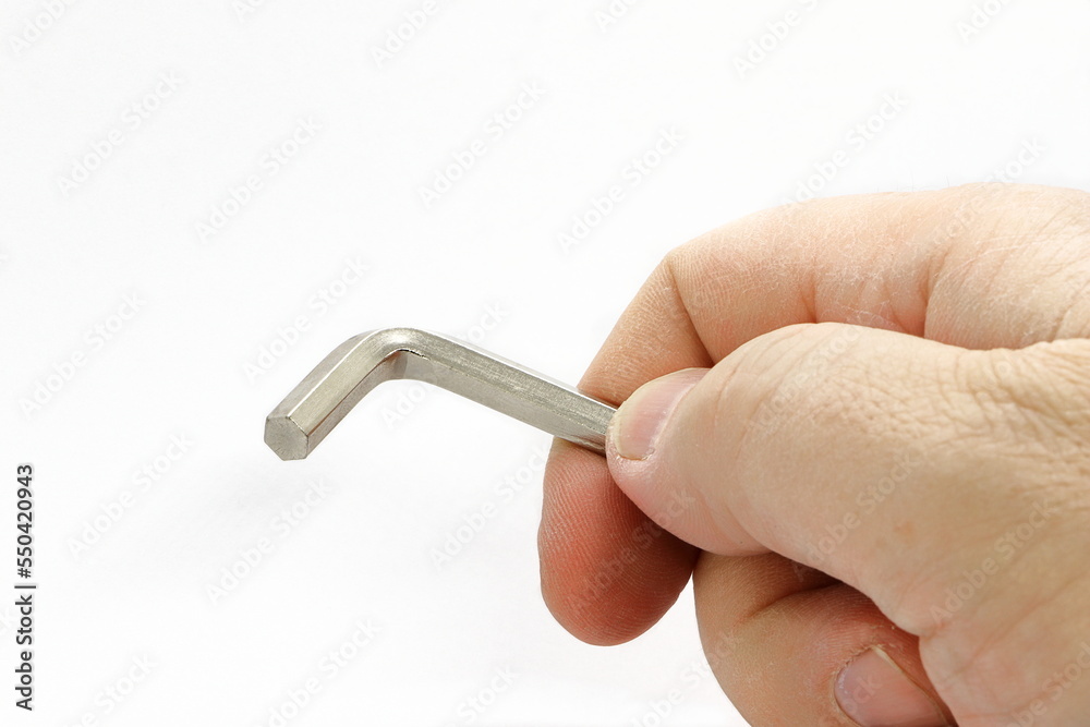 Hand holding Allen key. Isolated on white background. Stock Photo ...