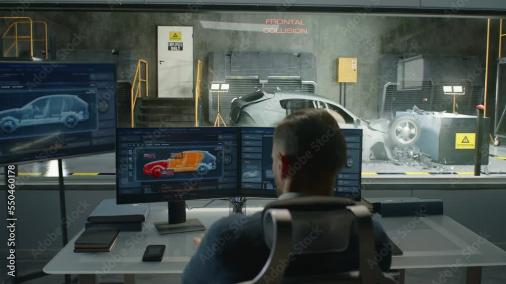 An engineer in a crash test lab uses a car crash test system to ...
