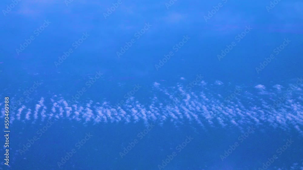 Cirrocumulus, granular cloudlets. Fleece clouds under the wing of an ...