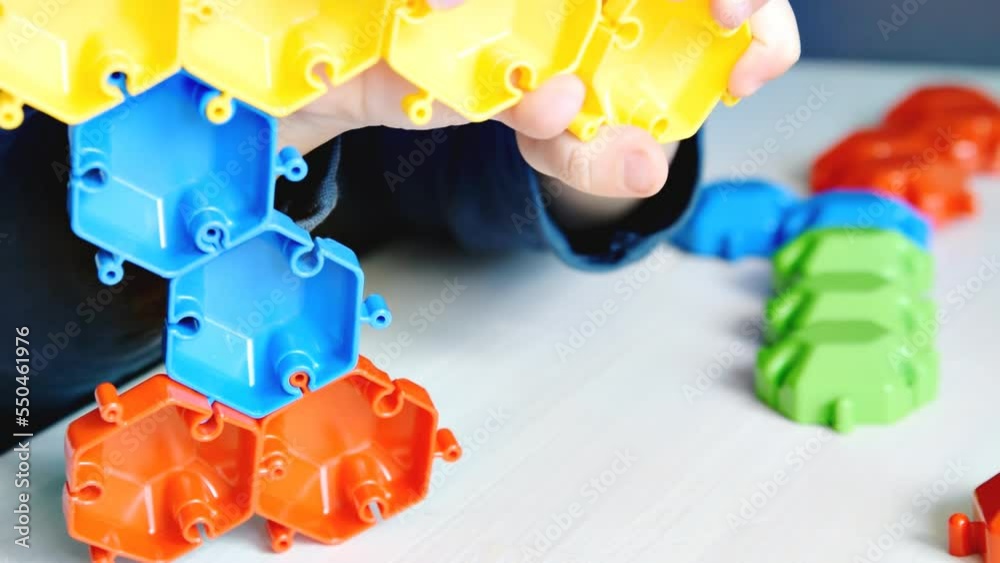 Little child boy playing with mosaic constructor.Babys hands building ...