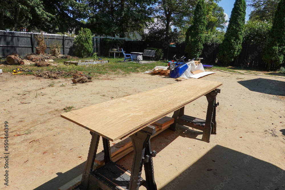 Two saw horses with plywood laying on top at a construction site Stock ...