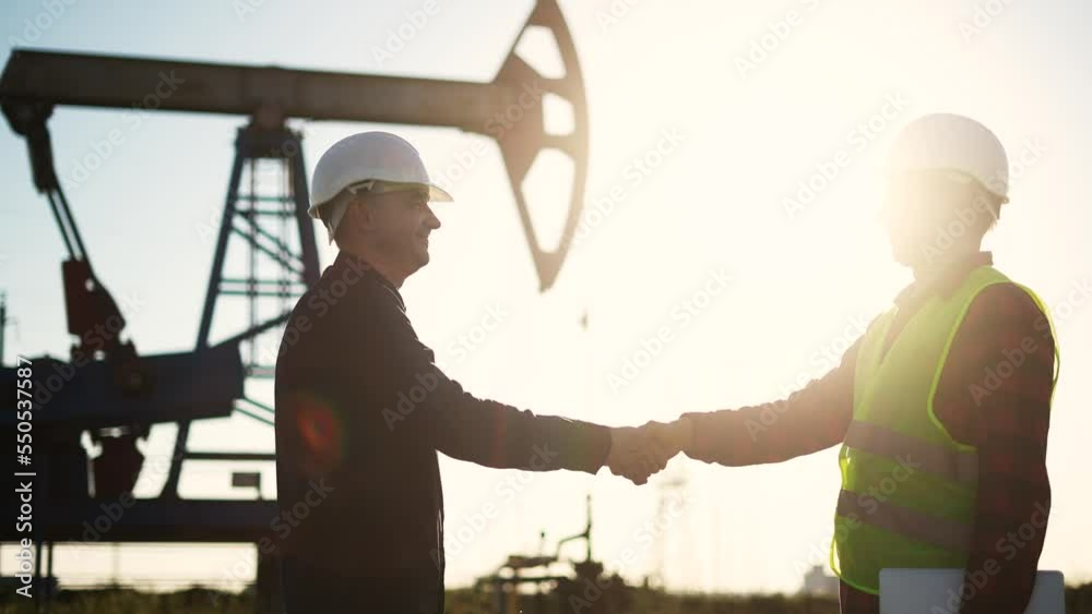 handshake business oil contract. handshake a worker and businessman ...