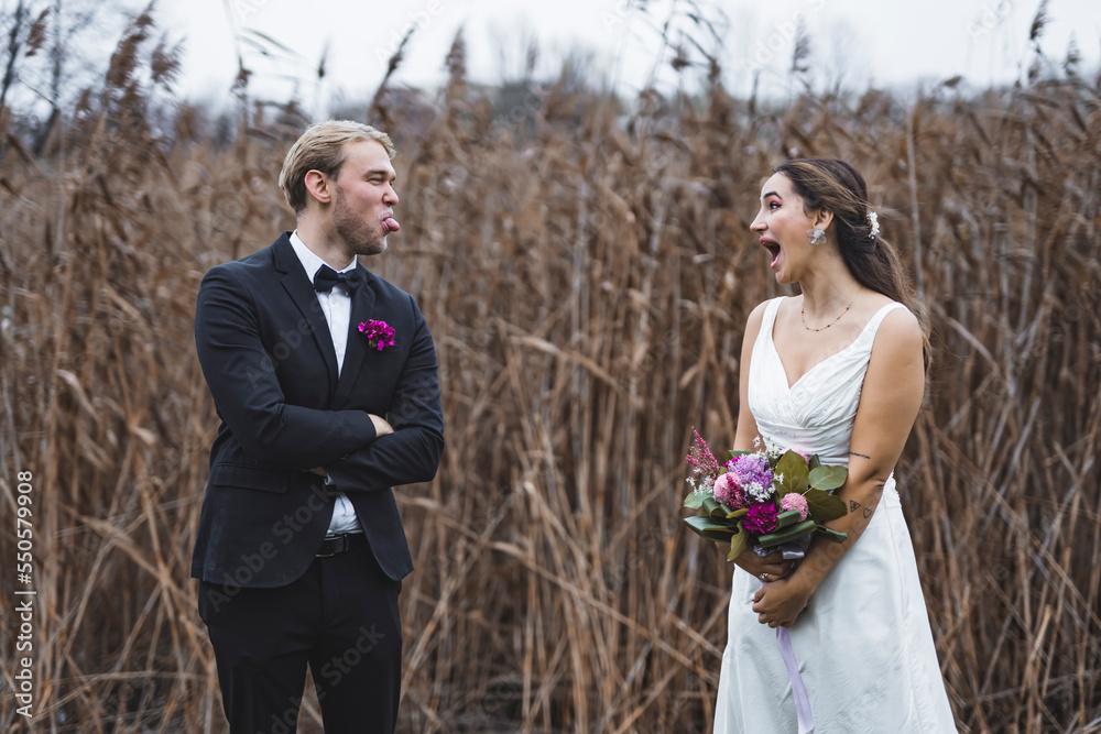 Newly married couple having fun, grimacing at each other. High quality ...