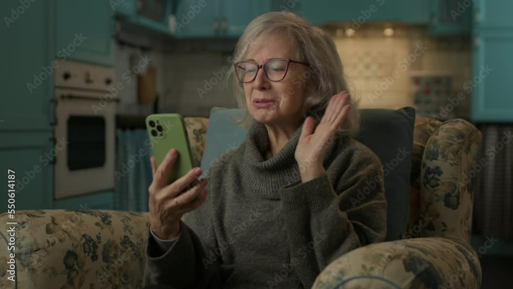 Elderly Woman Is On Video Call Using Mobile Phone. Senior woman ...