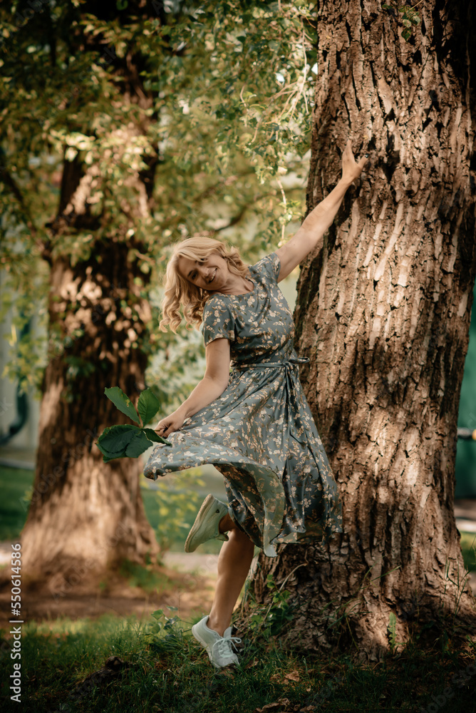 Foto de A girl with long blond hair walking in the park ran into a ...