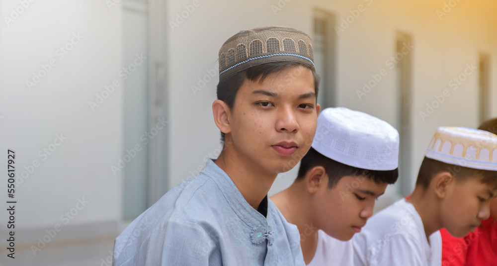 Portrait asian muslim or islamic boys sitting with muslim boys in a row ...