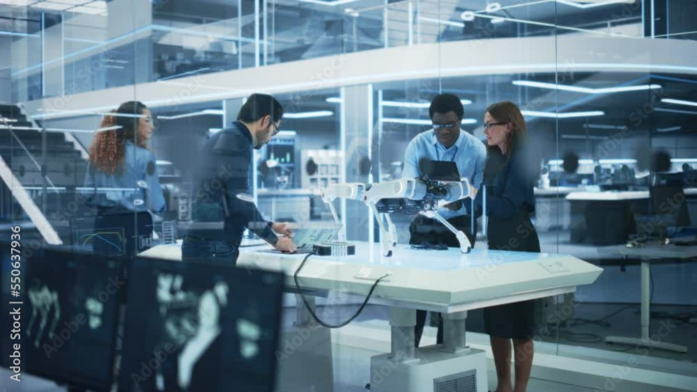 Diverse Colleagues Work in Industrial Robotics Factory, Experimenting ...