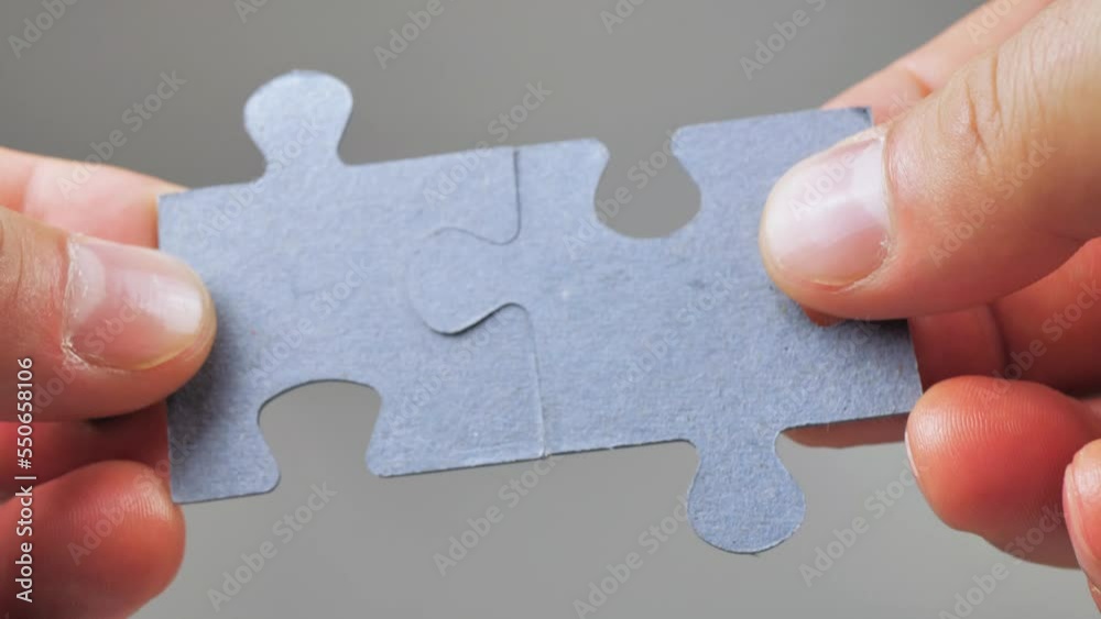 Close Up Hands of man Connecting Jigsaw Puzzle With Sunlight Affect ...