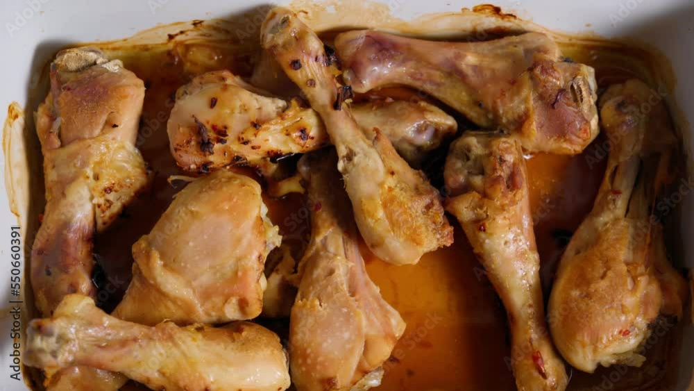 Baked chicken legs with a crispy crust in the oven. The oven is open ...