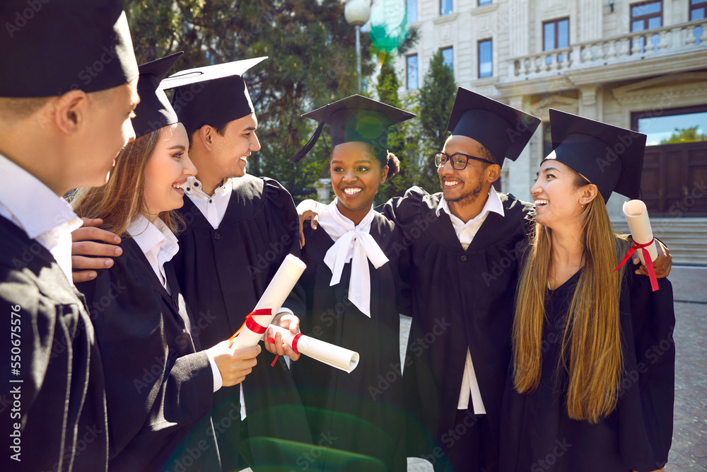 Live photo of happy talking group graduate people with diplomas after ...