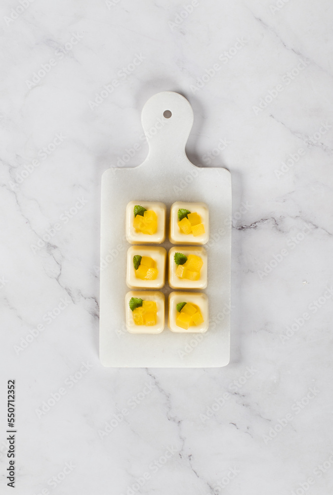 Mango cream jelly pudding, Panna Cotta in the form of small square ...
