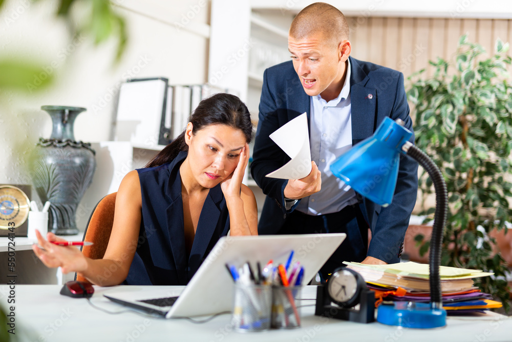 Angry boss criticizing sad frustrated employee sitting at office desk ...