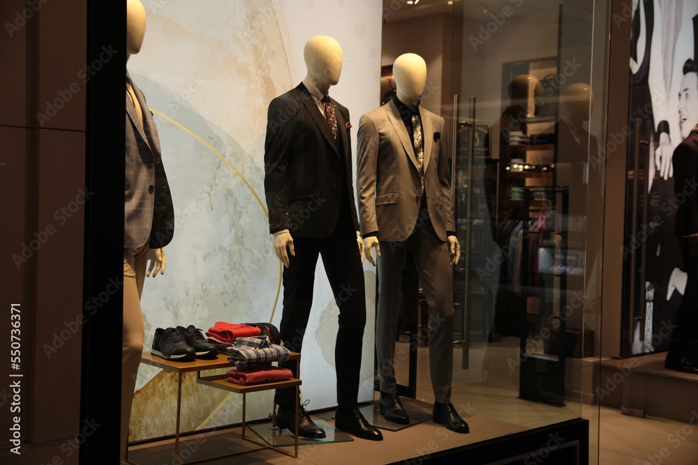 Beautiful suits on mannequins in showcases of fashion store Stock Photo ...