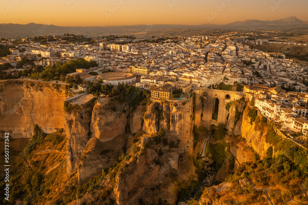 Aerial photo of Ronda, Spain, at sunset. The hilltop village is bathed ...