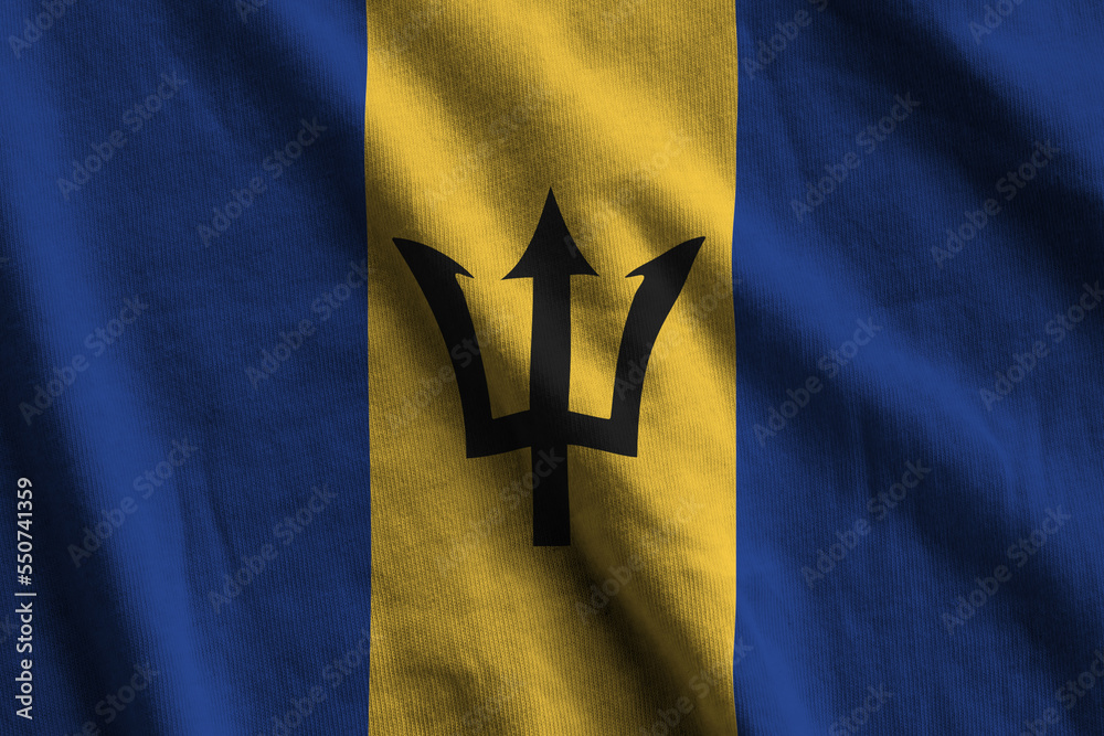 Barbados flag with big folds waving close up under the studio light ...