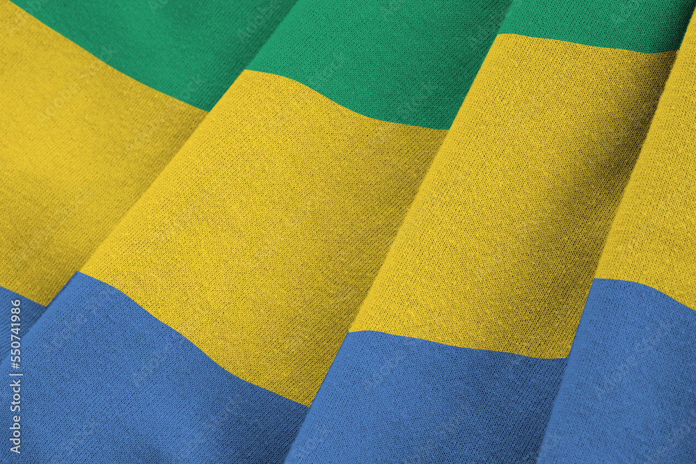 Gabon flag with big folds waving close up under the studio light ...