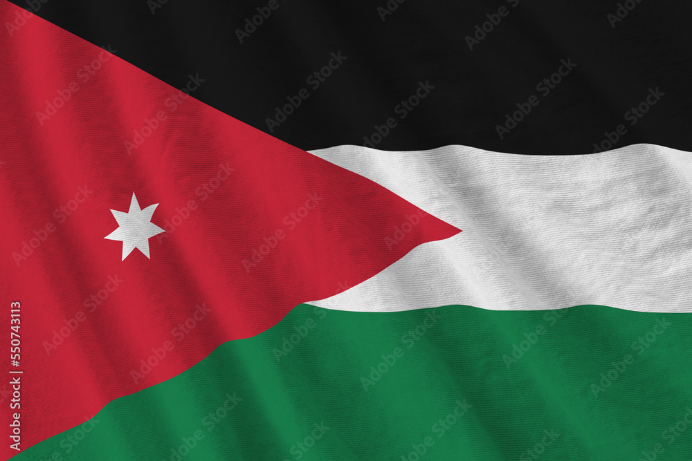 Jordan flag with big folds waving close up under the studio light ...