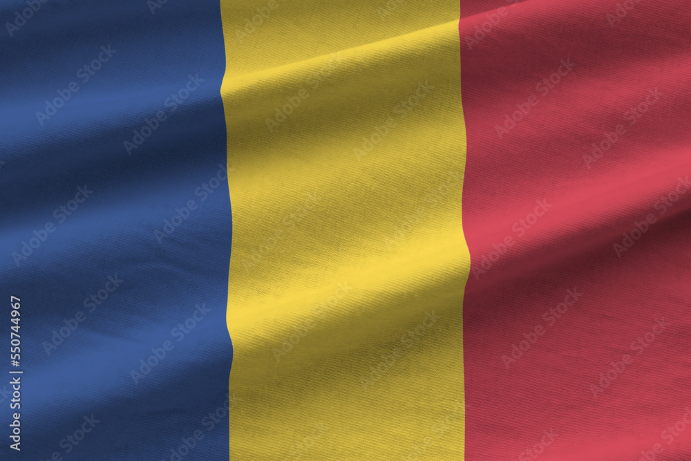 Romania flag with big folds waving close up under the studio light ...