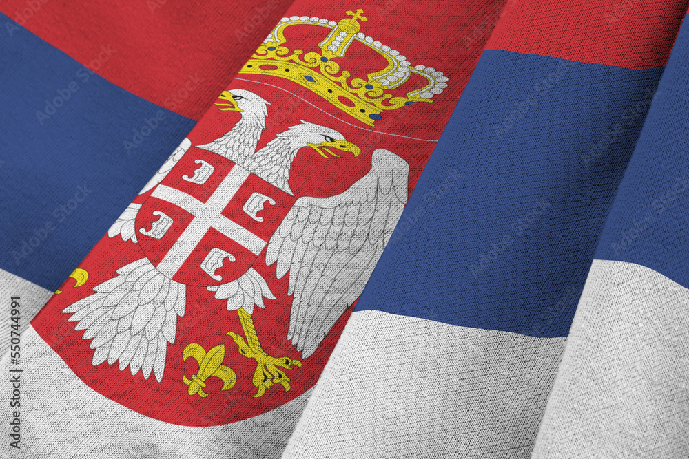 Serbia flag with big folds waving close up under the studio light ...