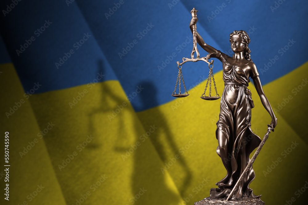 Ukraine flag with statue of lady justice and judicial scales in dark ...