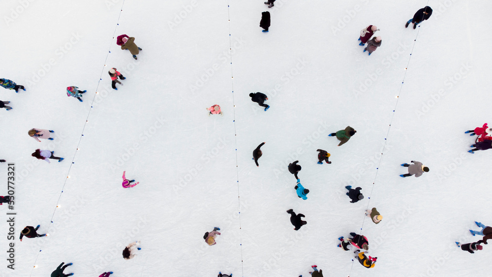 Top view of people skating on large open air ice rink on winter day ...