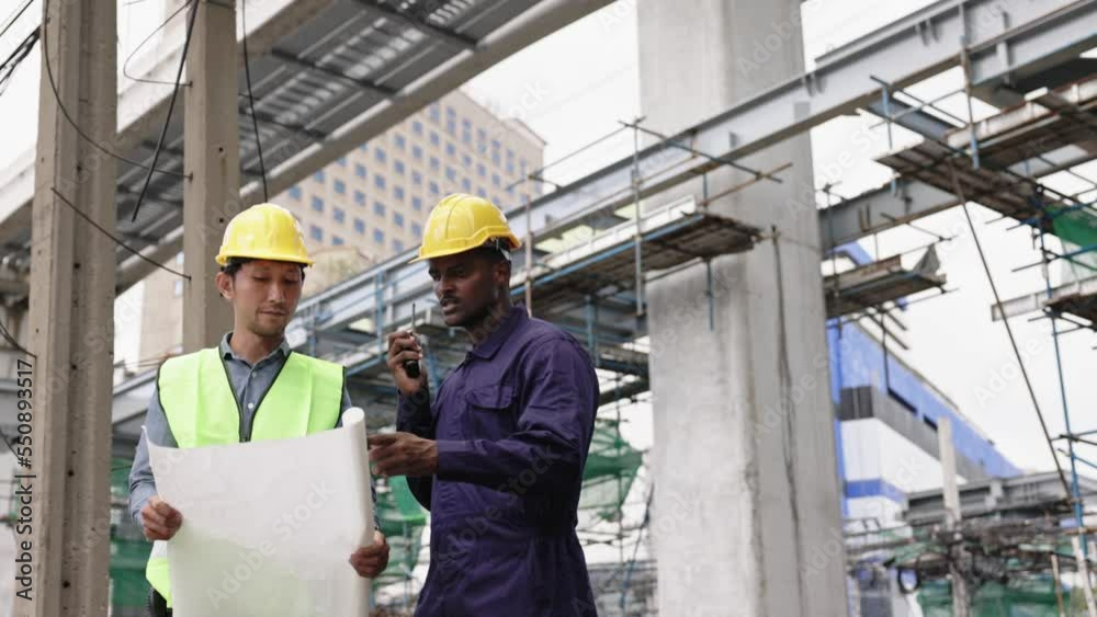 Structural engineers and construction workers are holding blueprints ...