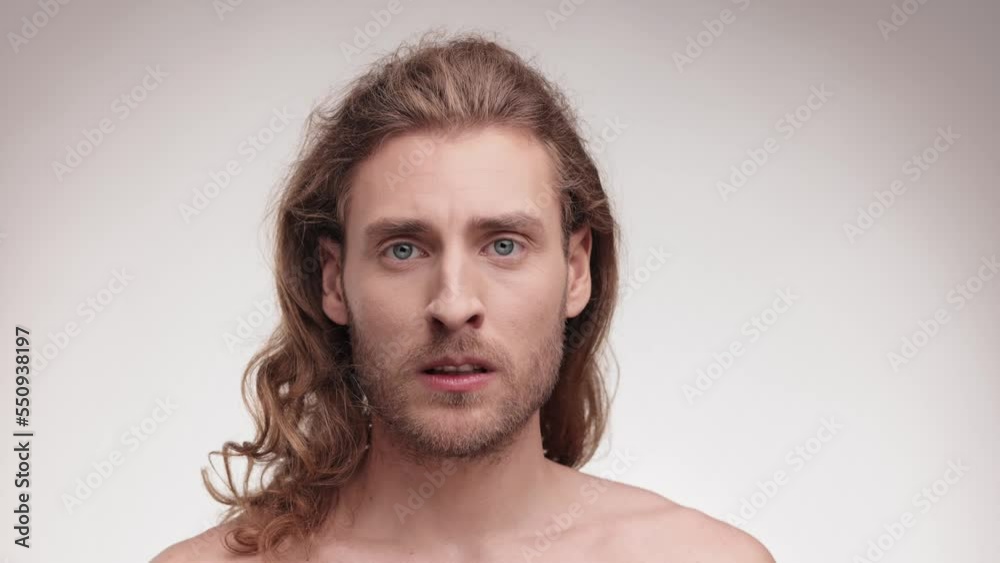 Angry curly man can't comb his hair and throws out a comb. Face happy ...