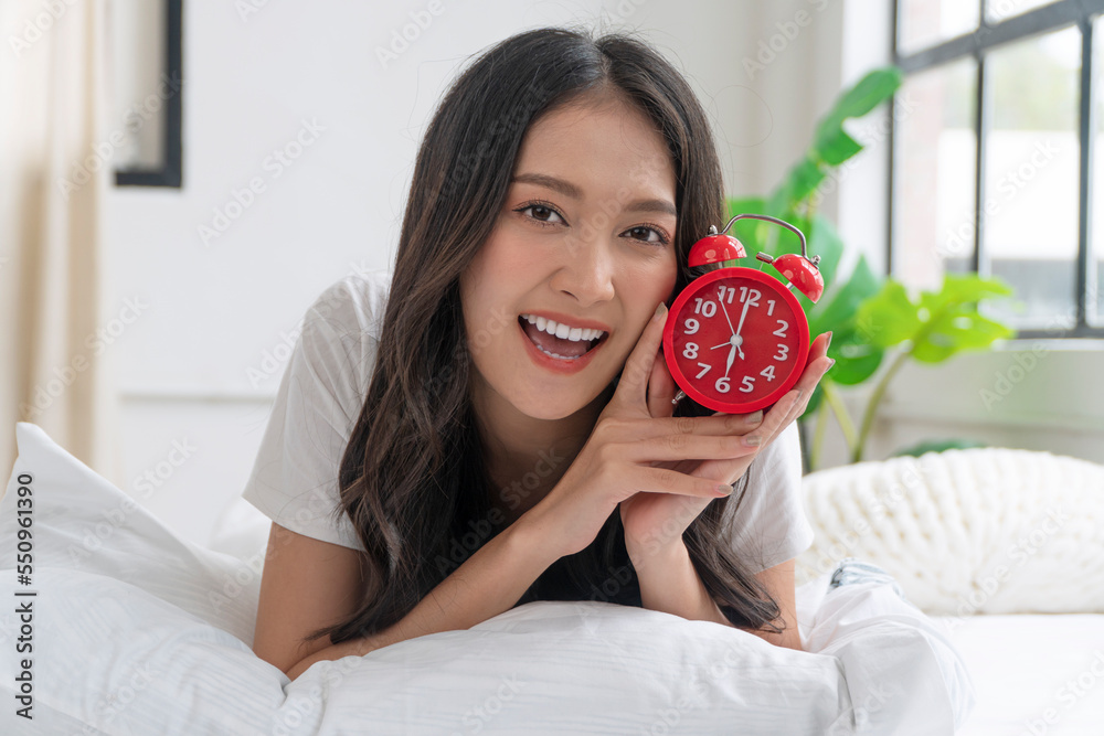 Beautiful cheerful asian woman early wake up lying relax on pillow ...