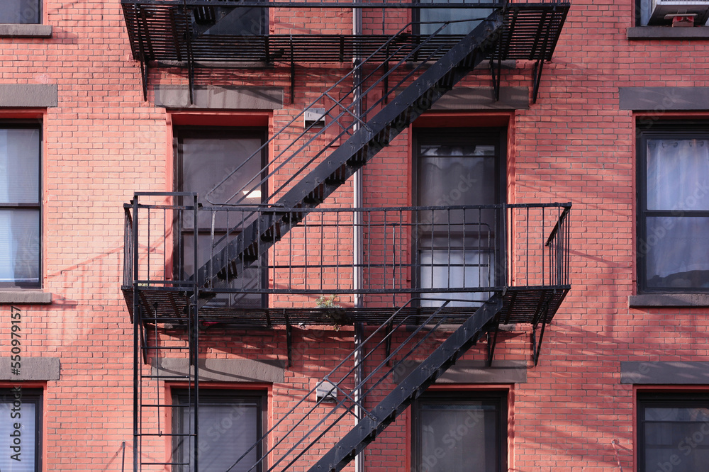 Close up New York City apartment building painted red brick exterior ...