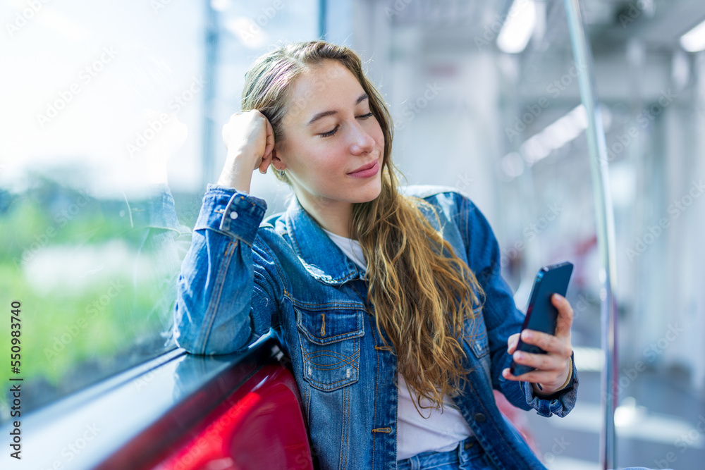 Cheerful young female traveling, standing in MRT train station ...