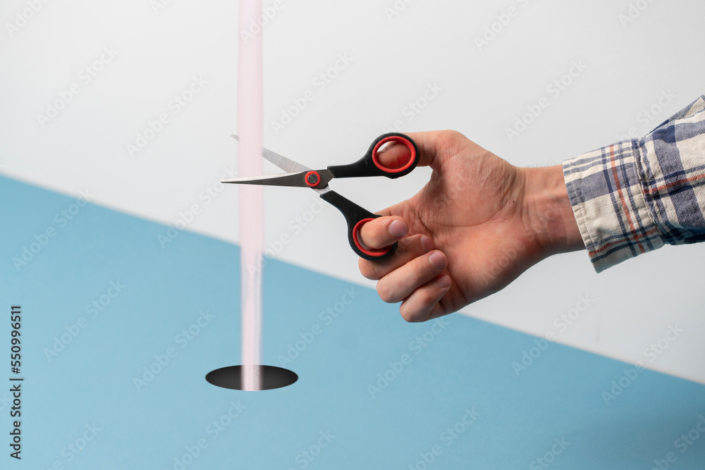 hand holding scissors and cut water flow as a symbol of water economy ...